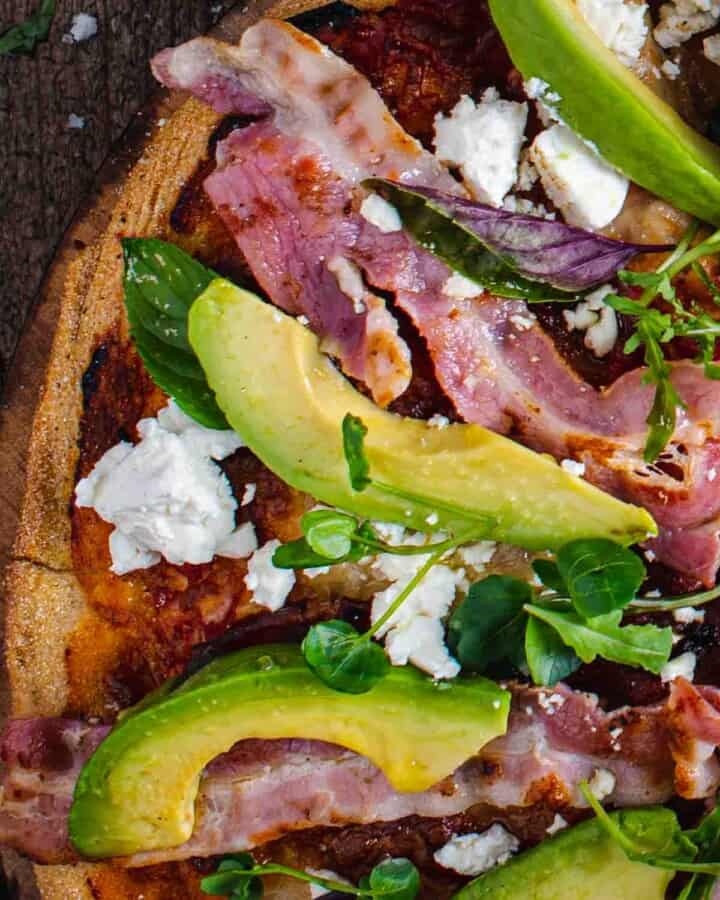 Homemade bacon pizza with feta and avocado